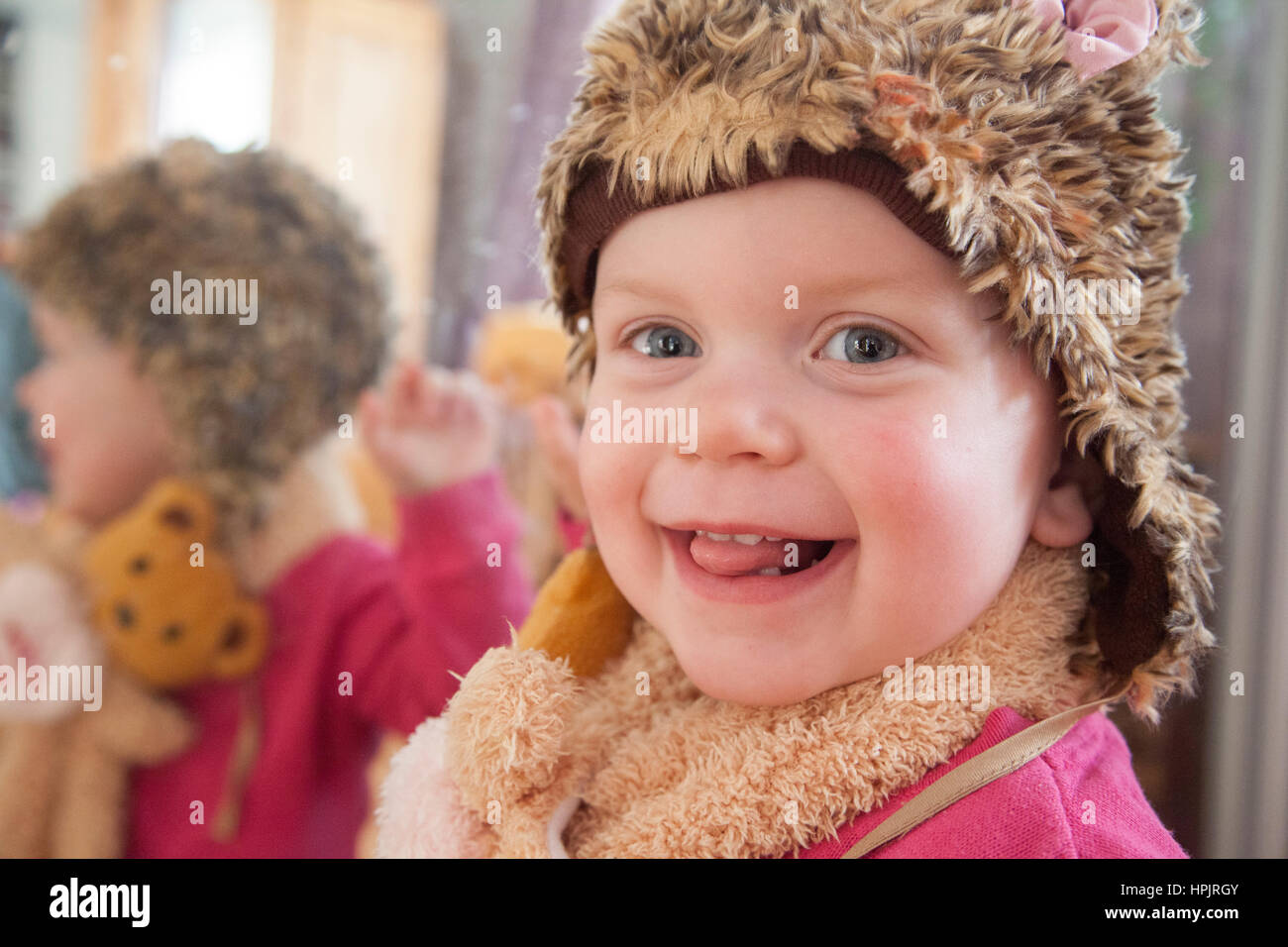 Smiling baby girl with hat on her head Stock Photo - Alamy