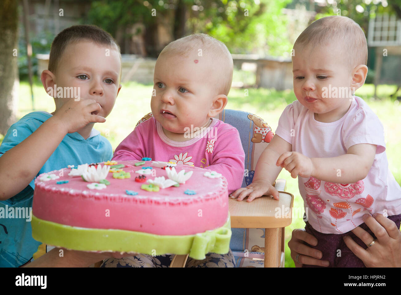 Child celebrating one year birthday with celebration fruit cake Stock ...