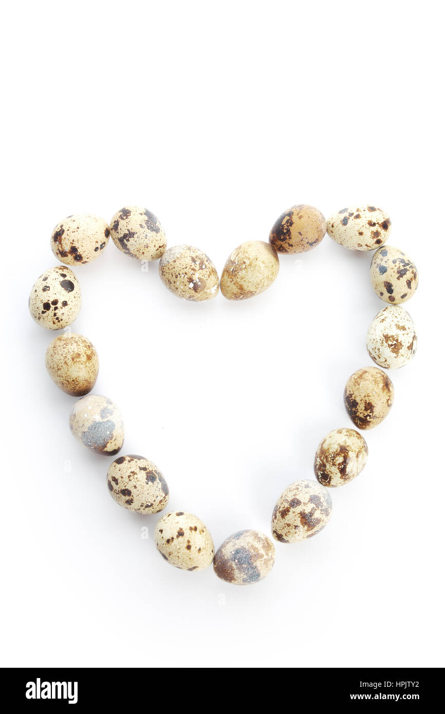 Quail eggs in heart shape isolated on white background Stock Photo - Alamy