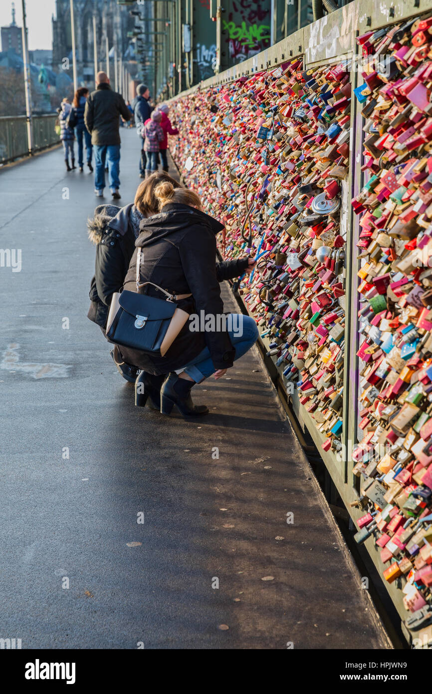 Two girls looking at the Love Locks on the Hohenzollern Bridge over the ...