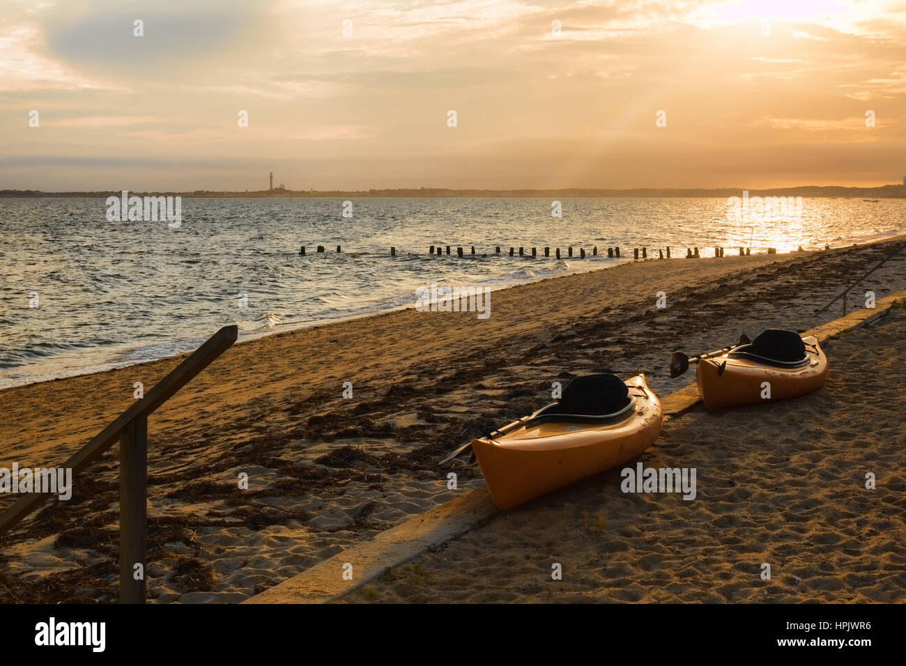 Two kayaks waiting on the beach under a brilliant sunset in Truro, Cape ...