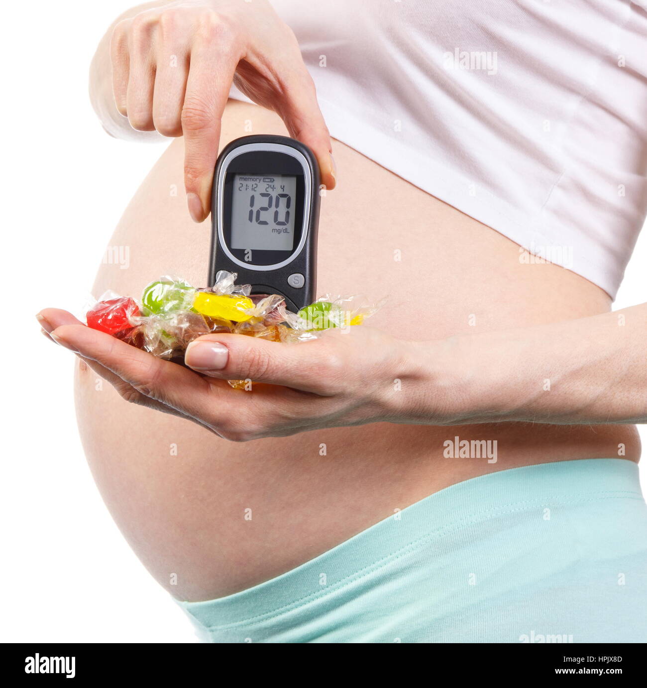 Pregnant woman holding colorful candies and glucose meter with result ...