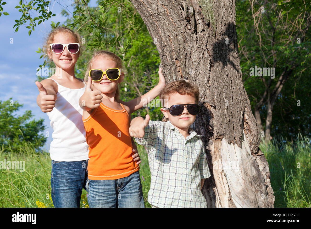 Three happy children playing in the park at the day time. Concept ...