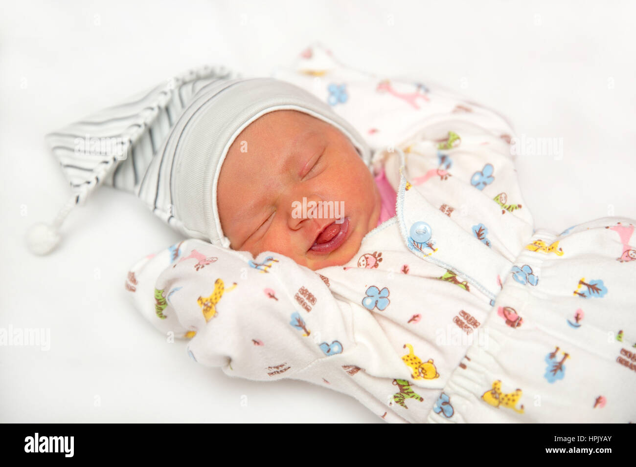 A cute newborn baby girl sleeping. Sweet little baby portrait. Use the ...