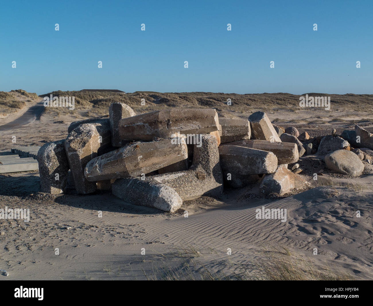 beach with concrete pillars that serve as coastal protection against ...