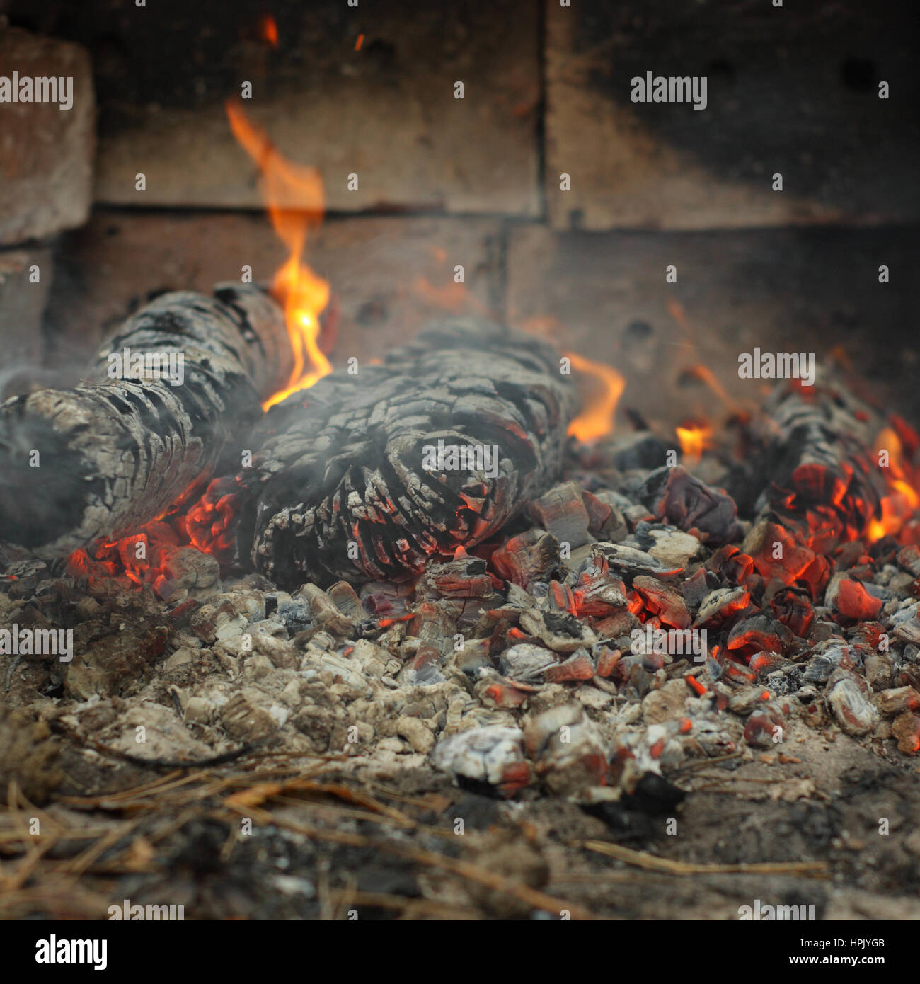 Embers and fire above firebrand in hearth, shallow DOF Stock Photo - Alamy