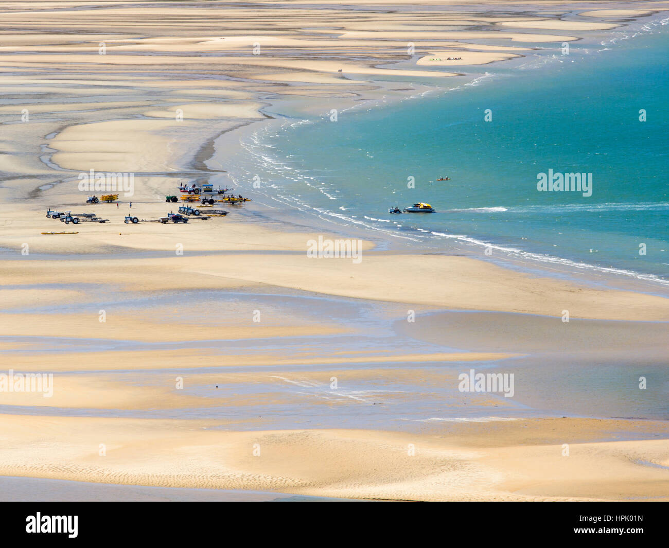 Marahau, Tasman, New Zealand. View over Sandy Bay at low tide, tractor ...