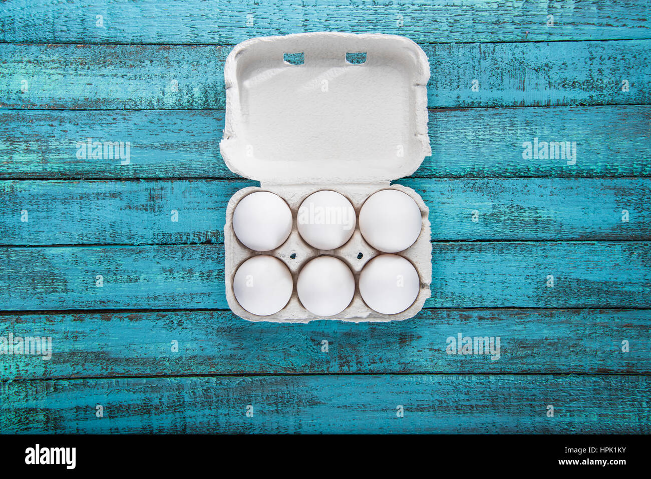 Top view of raw chicken eggs in open carton box on table Stock Photo ...