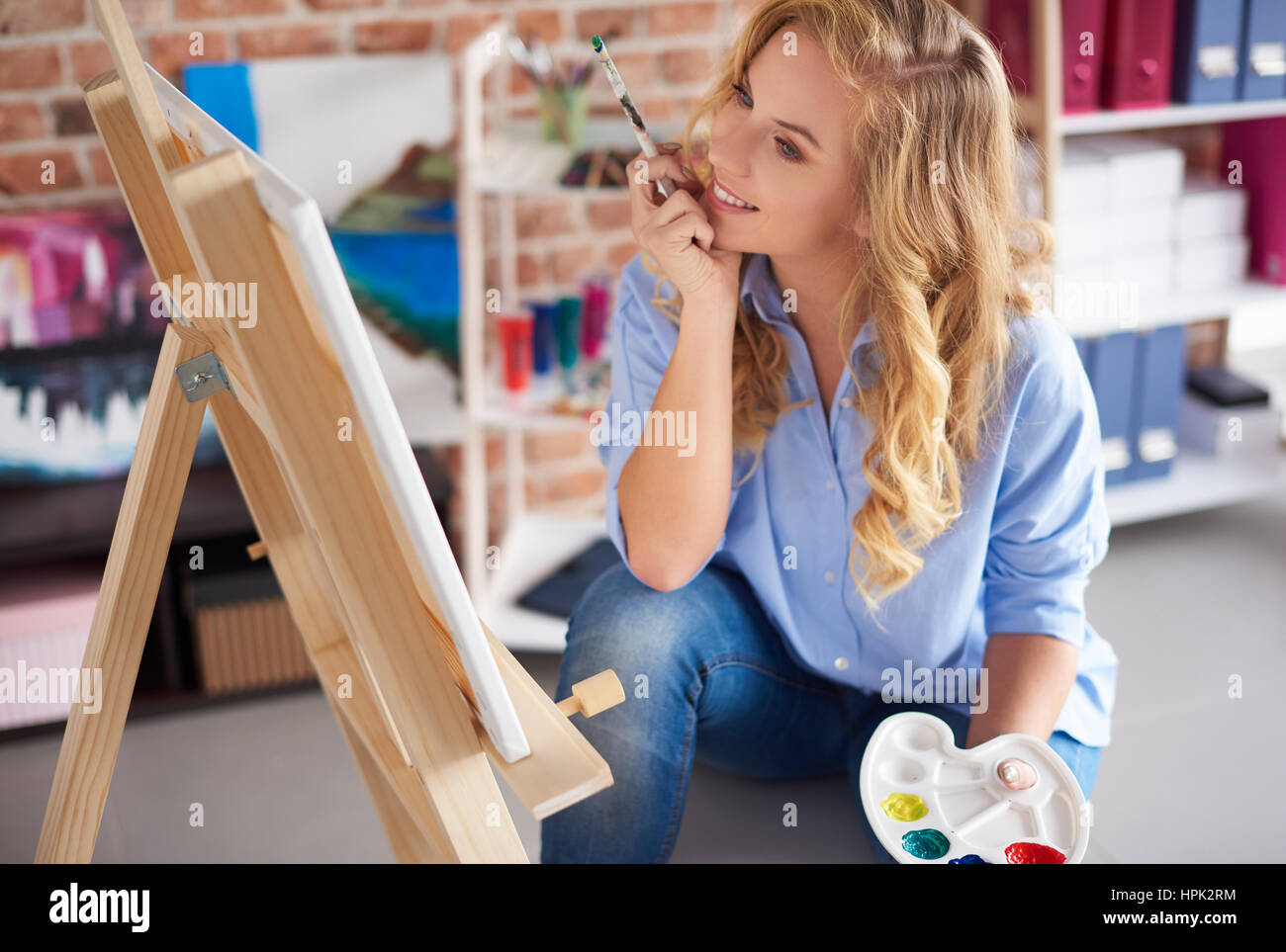 Female artist looks at her project Stock Photo - Alamy