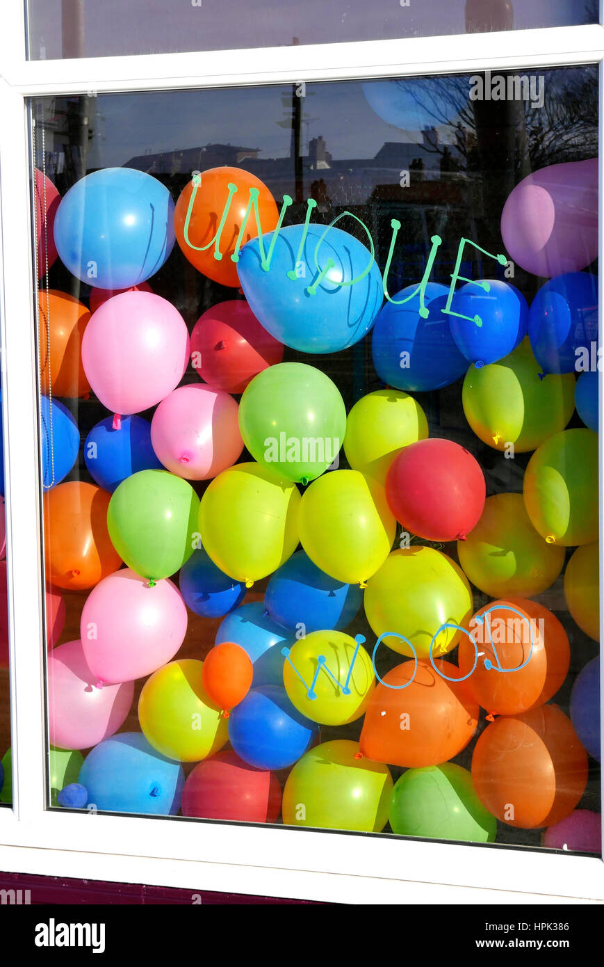 Colourful balloons in gift shop window Stock Photo - Alamy