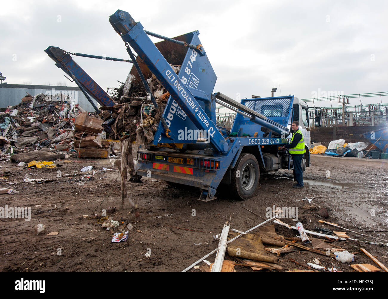 Skip lorry emptying its load of rubbish for recycling Stock Photo - Alamy