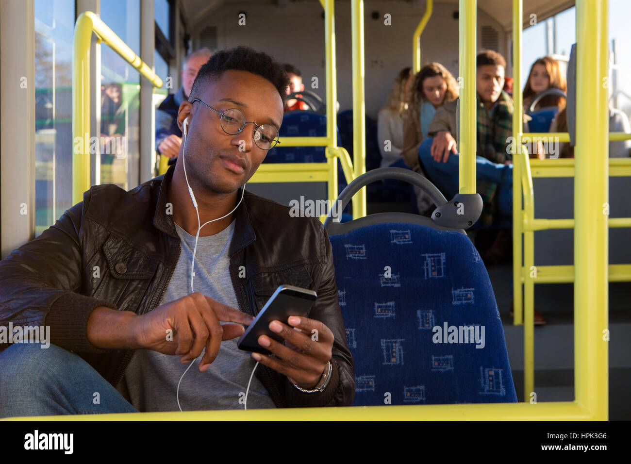 Man on bus using phone hi-res stock photography and images - Alamy