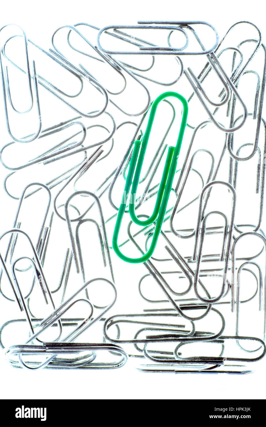 One green paper clip against background of others Stock Photo - Alamy