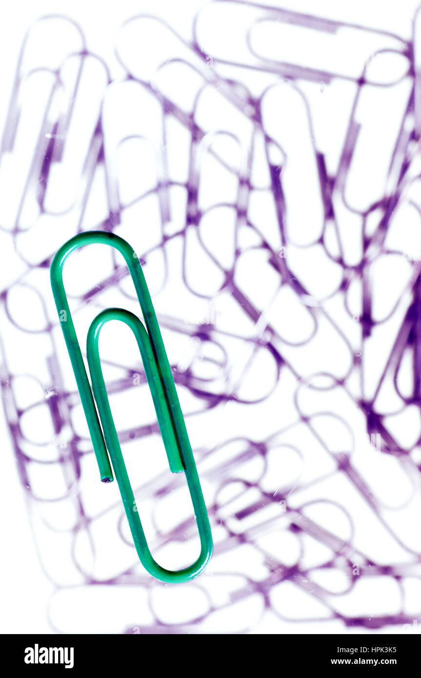 One green paper clip against background of others Stock Photo - Alamy