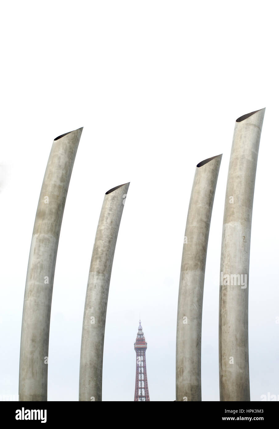 Curved vertical steel pipes and Blackpool Tower Stock Photo - Alamy