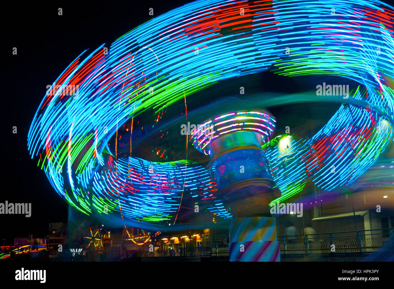 Moving fairground ride at night Stock Photo - Alamy