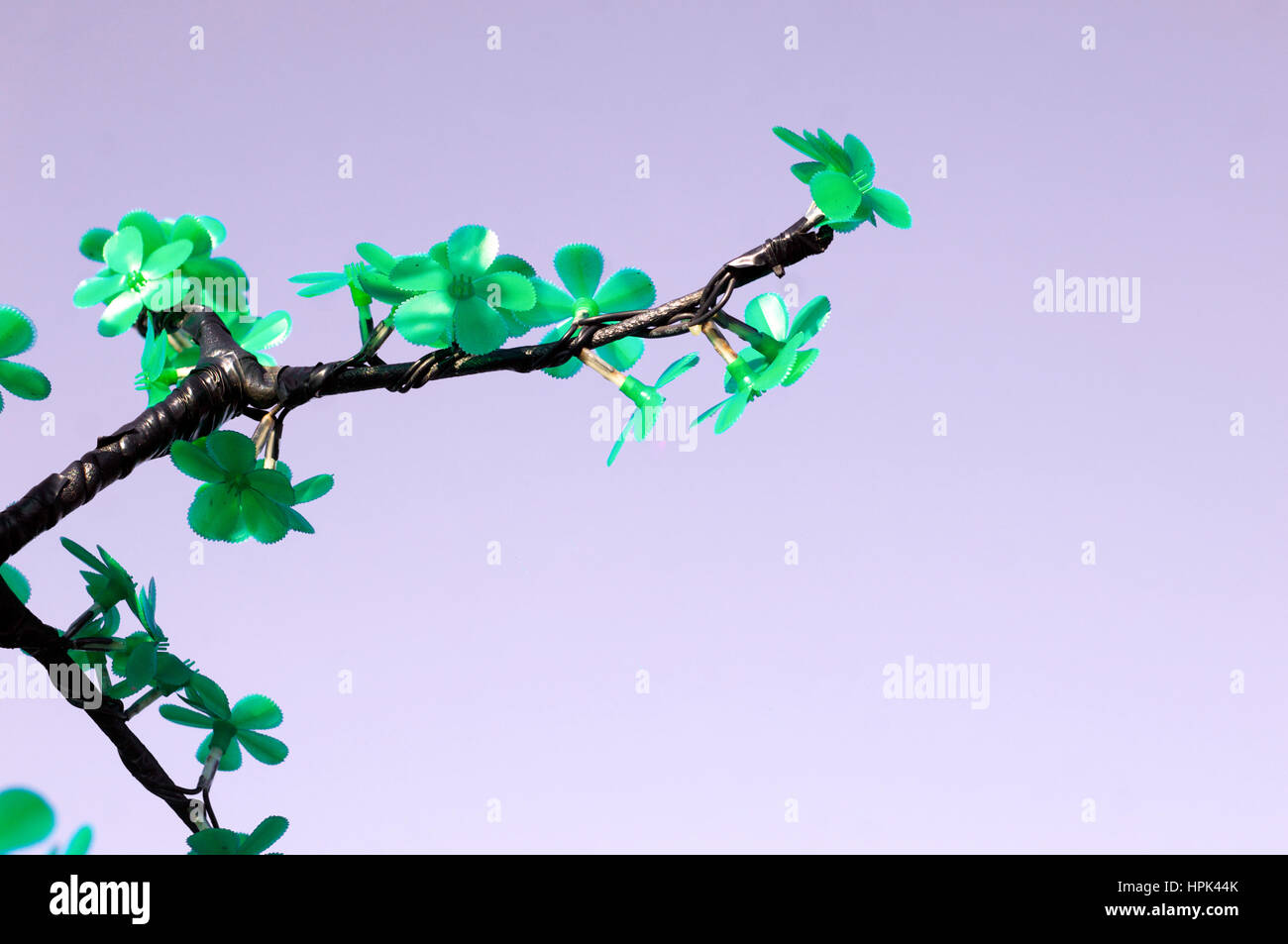 Plastic tree branch and leaves against purple background Stock Photo ...