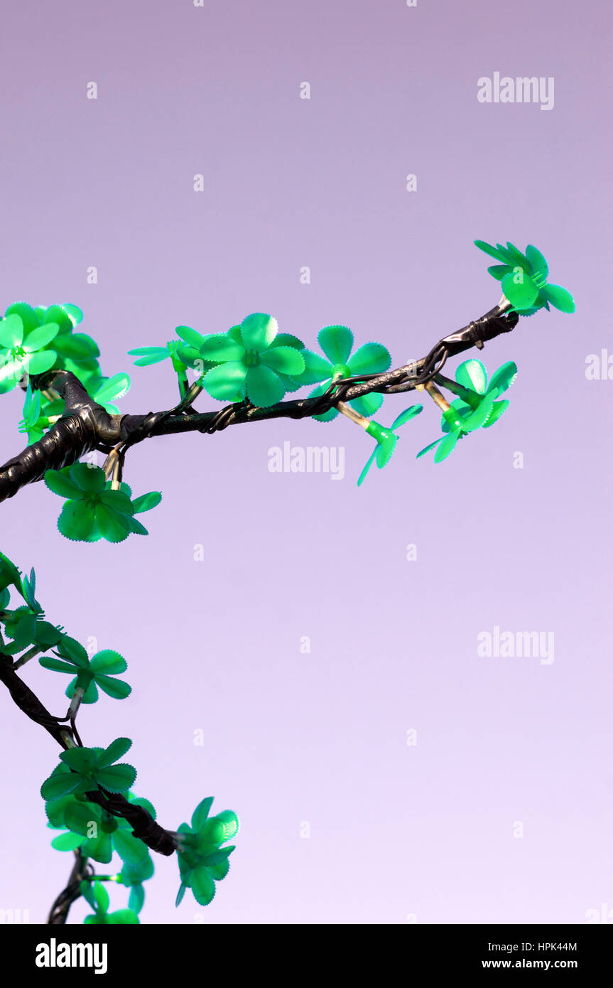 Plastic tree branch and leaves against purple background Stock Photo ...