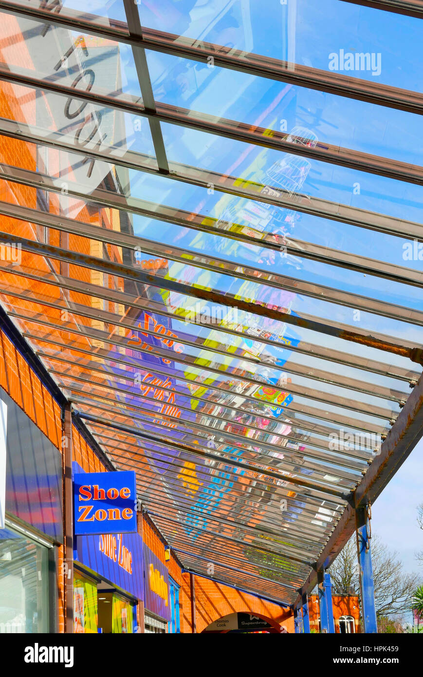 Reflection of shop signs in overhead glass canopy Stock Photo - Alamy