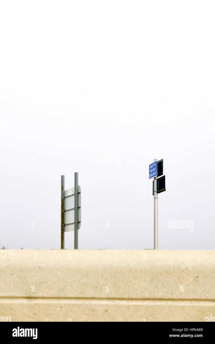 Road traffic signs showing over concrete wall Stock Photo - Alamy