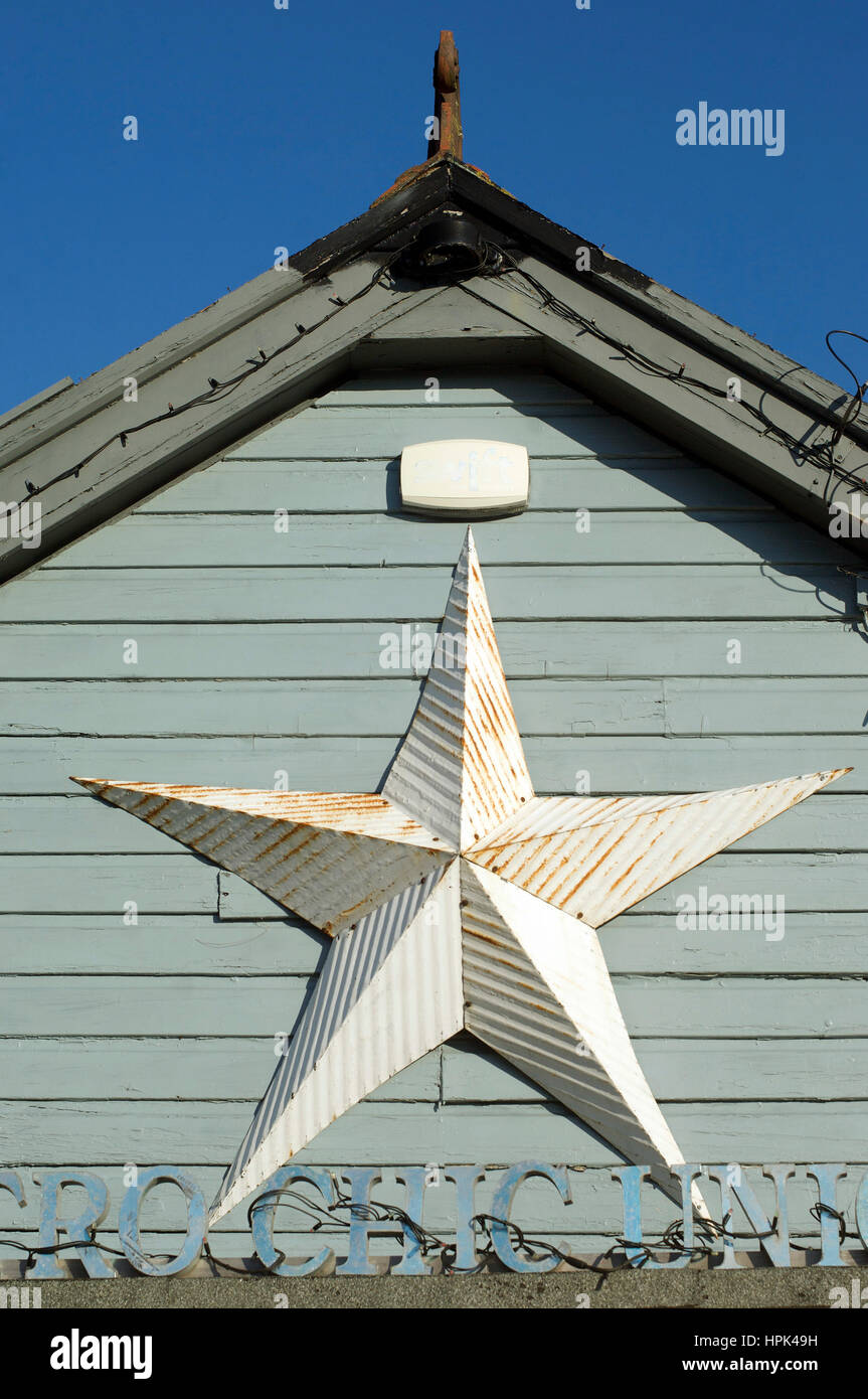 Large white star on side of green wooden building Stock Photo - Alamy