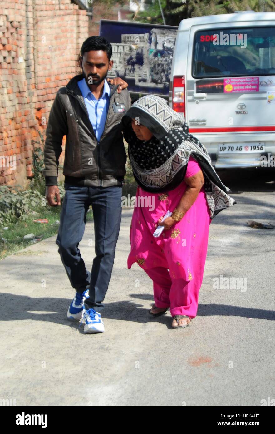 Allahabad, India. 23rd Feb, 2017. A boy with his mother going to a ...