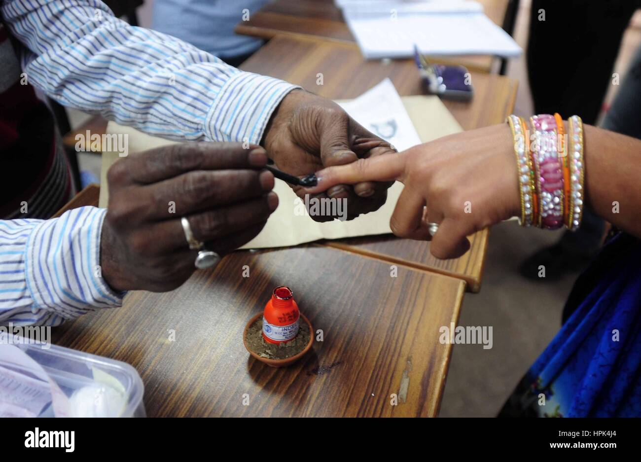Allahabad, India. 23rd Feb, 2017. A polling officer mark in a finger of ...