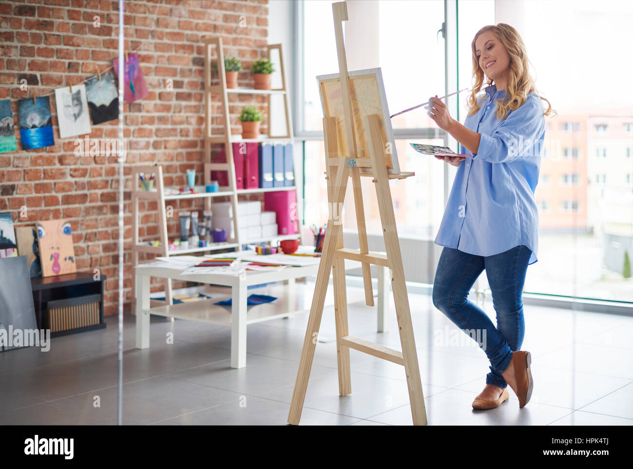 Creative woman working in art studio Stock Photo - Alamy