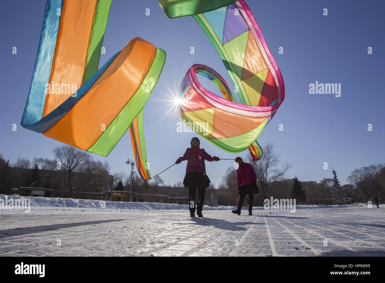 Jilin, China. 23rd Feb, 2017. Women wave colourful ribbons to celebrate ...
