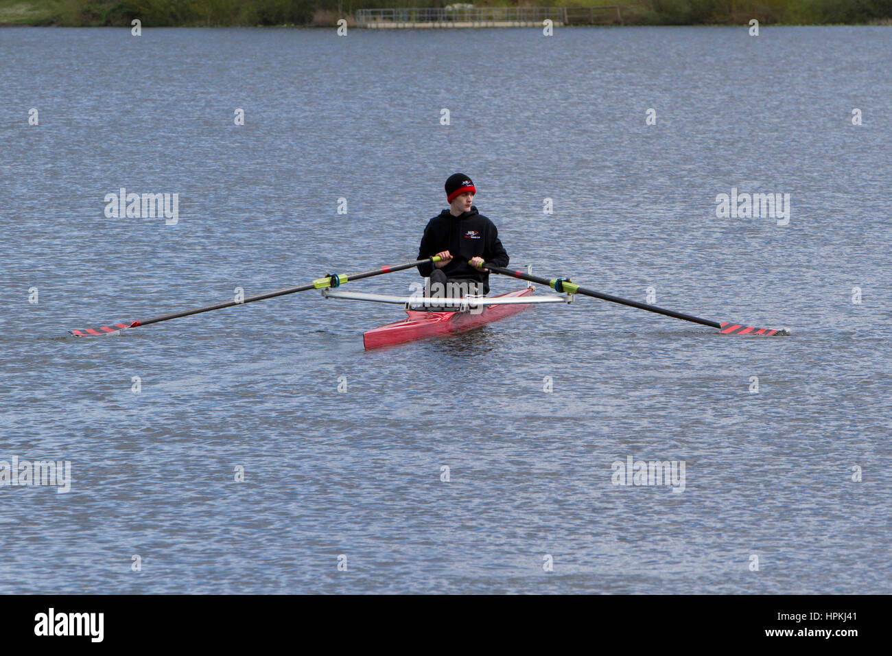 A teenage rower sportsman, on a river in a singles rowing boat Stock ...