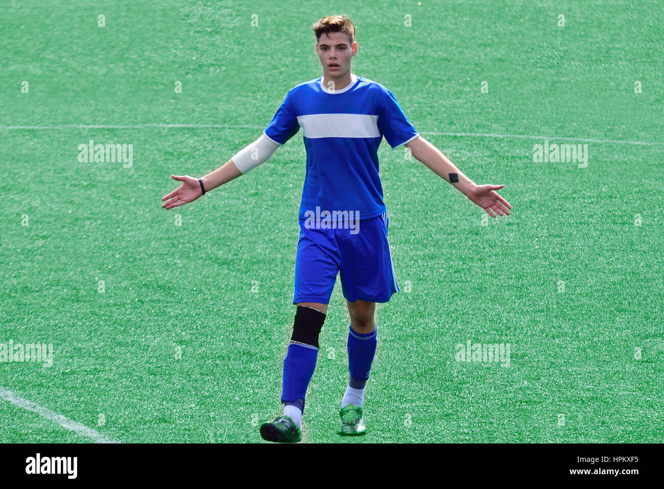 Surprised Soccer player in blue uniform at the stadium during the match ...