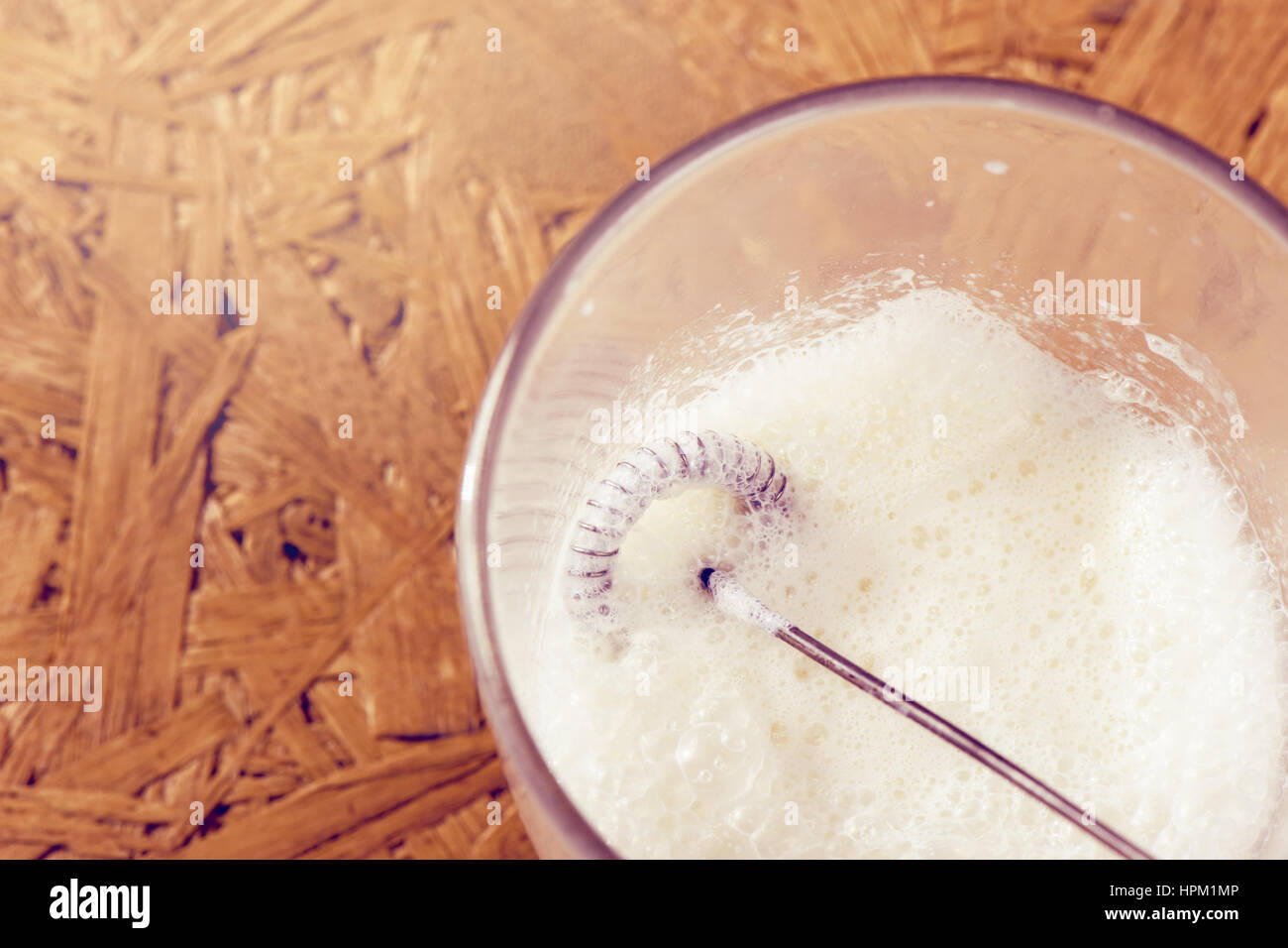 making foamy milk with milk frother, home cooking Stock Photo - Alamy