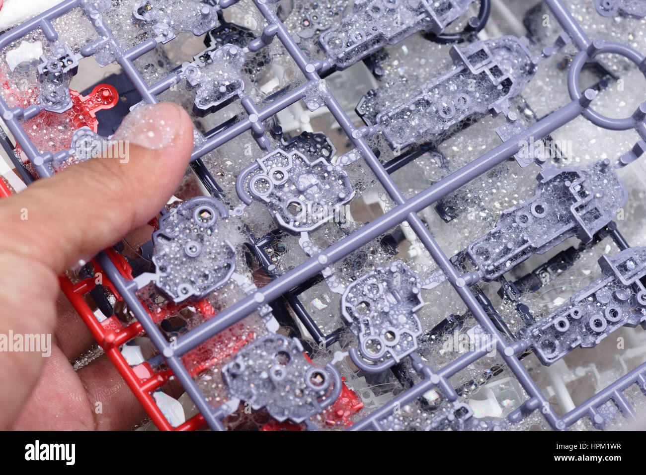 cleaning the sprue or injection moulding of toy Stock Photo - Alamy