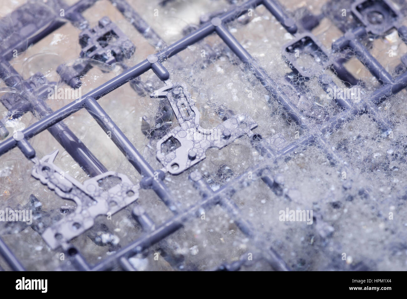 cleaning the sprue or injection moulding of toy Stock Photo - Alamy