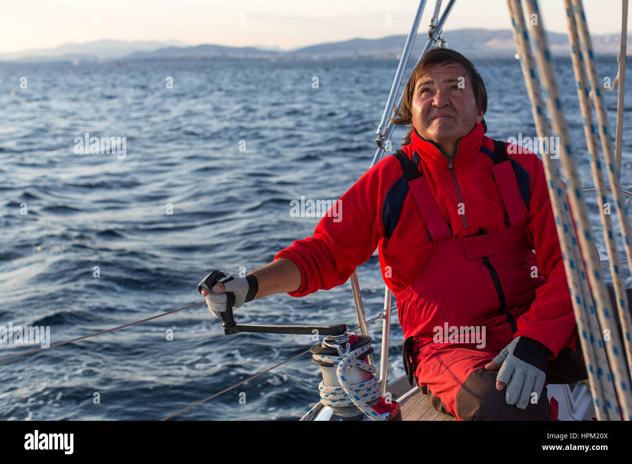 Man on his sailing yacht Stock Photo - Alamy