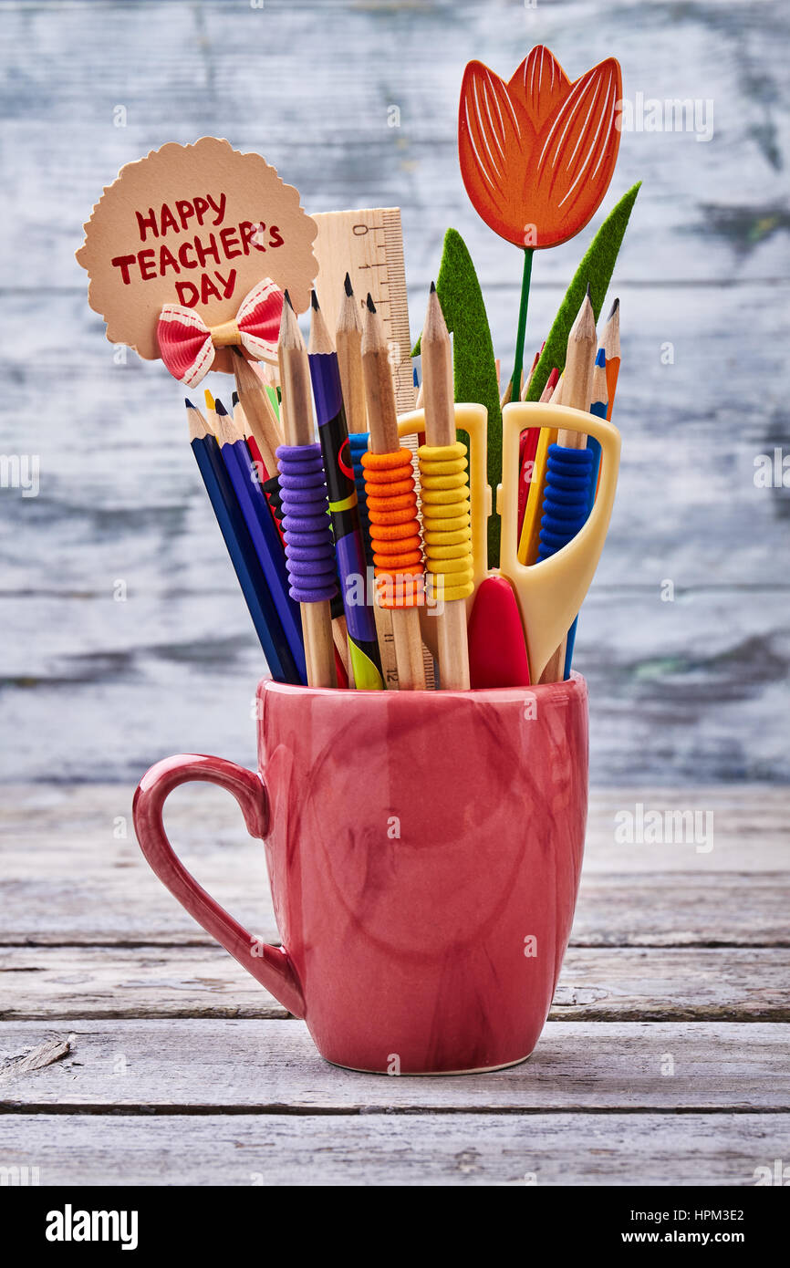 Crayons, card, cup and scissors Stock Photo - Alamy