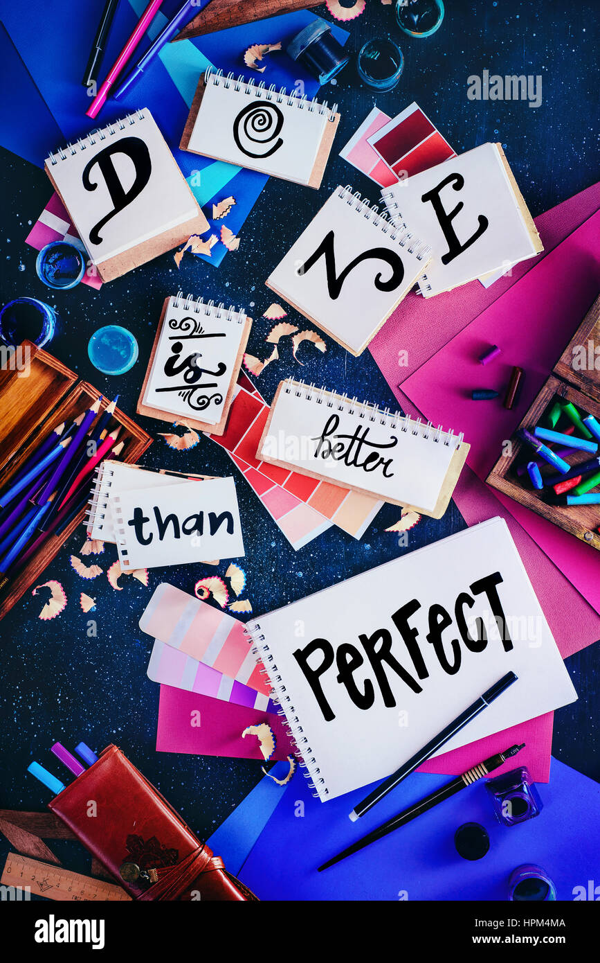 Quote lettering "Done is Better than Perfect" on a variety of notepads ...