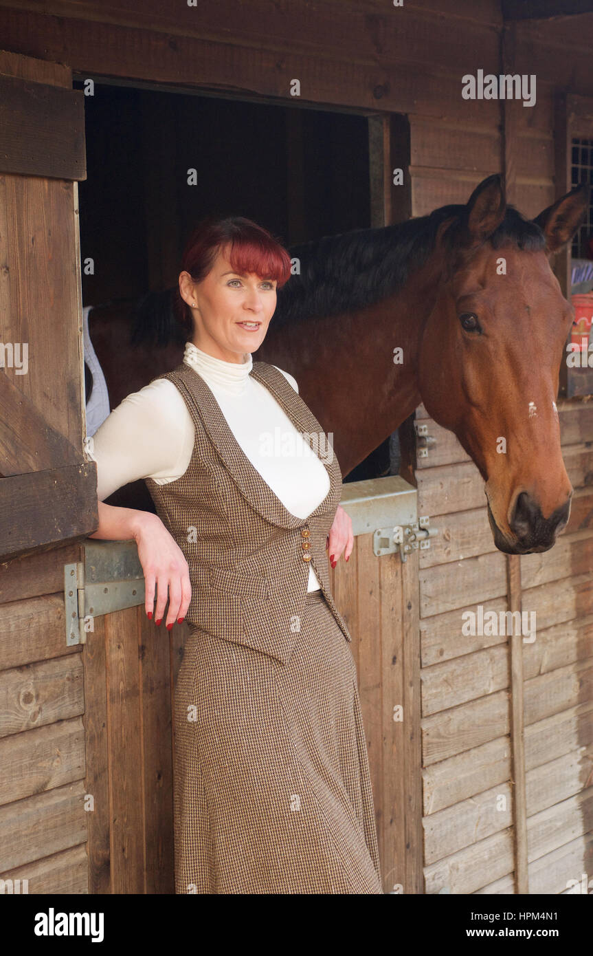 Beautiful woman in gamekeepers tweed suit at a stable Stock Photo - Alamy