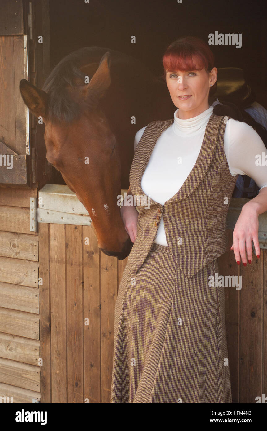 Beautiful woman in gamekeepers tweed suit at a stable Stock Photo - Alamy