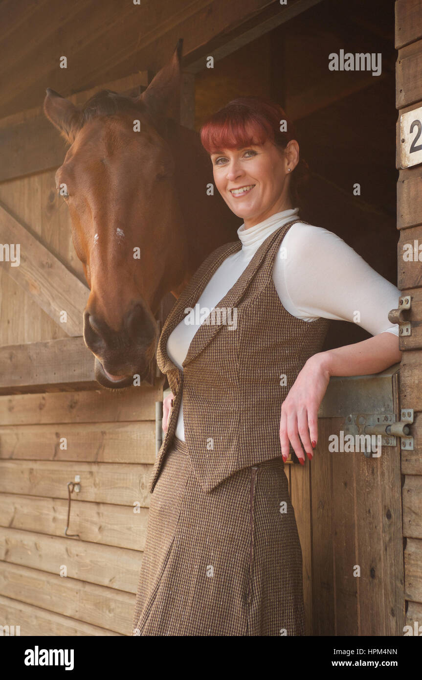 Beautiful woman in gamekeepers tweed suit at a stable Stock Photo - Alamy