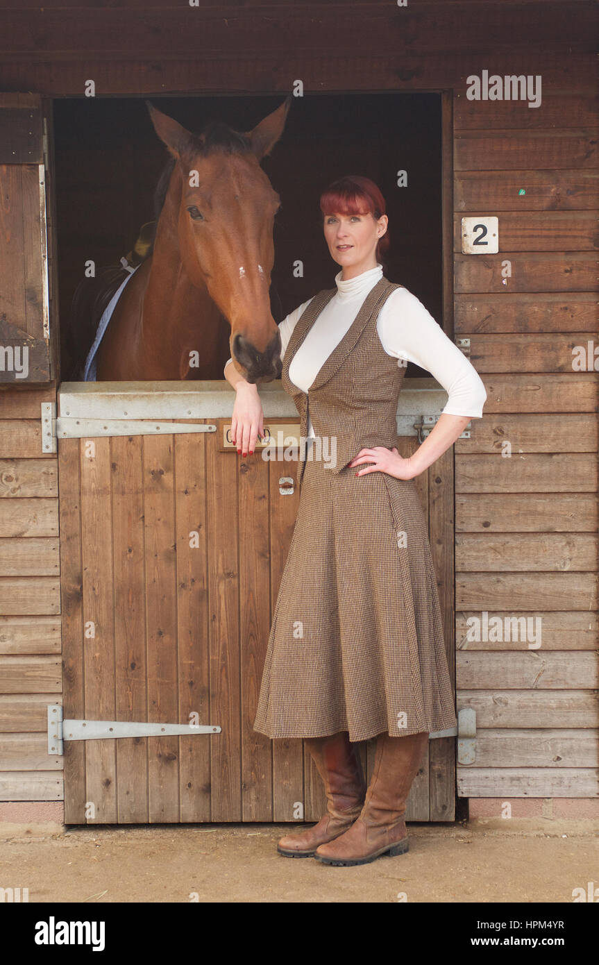 Beautiful woman in gamekeepers tweed suit at a stable Stock Photo - Alamy