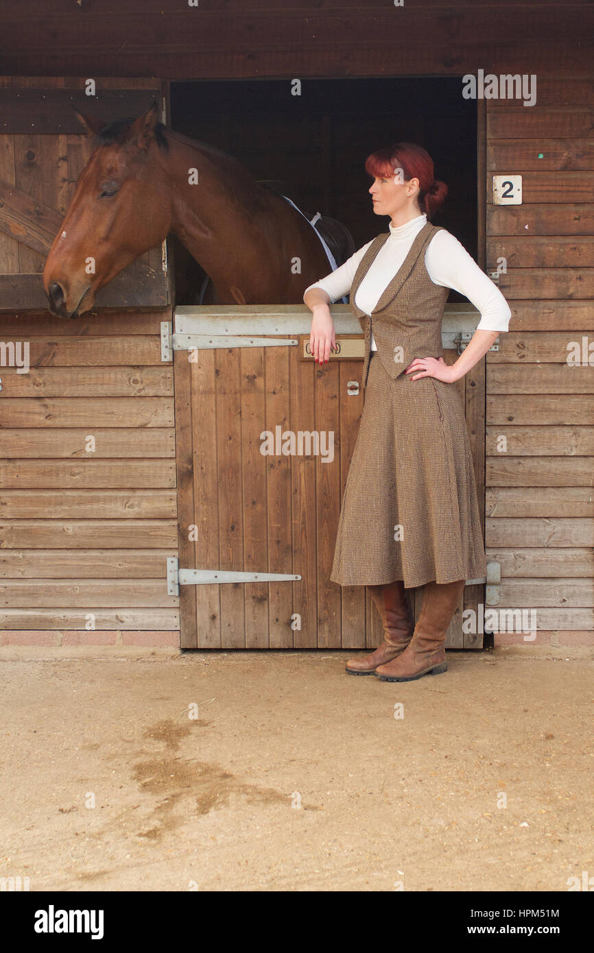 Beautiful woman in gamekeepers tweed suit at a stable Stock Photo - Alamy