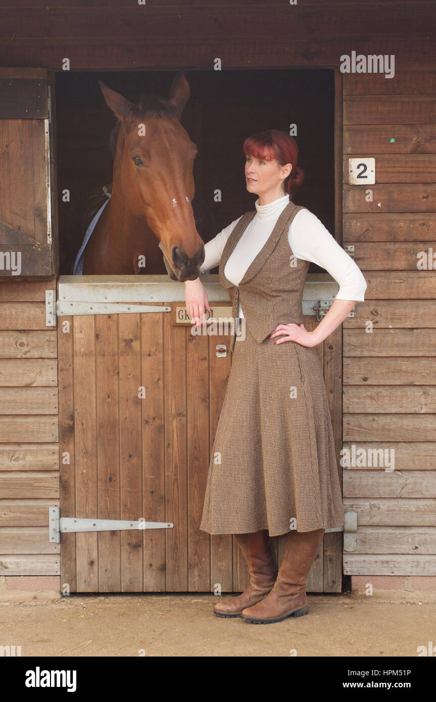 Beautiful woman in gamekeepers tweed suit at a stable Stock Photo - Alamy