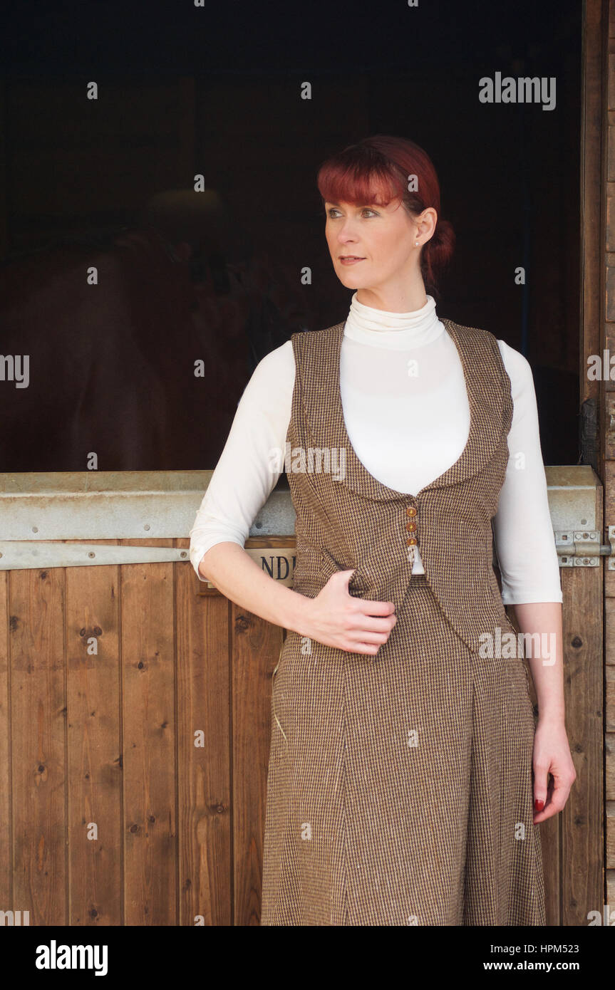 Beautiful woman in gamekeepers tweed suit at a stable Stock Photo - Alamy