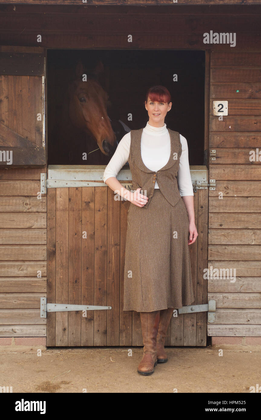 Beautiful woman in gamekeepers tweed suit at a stable Stock Photo - Alamy