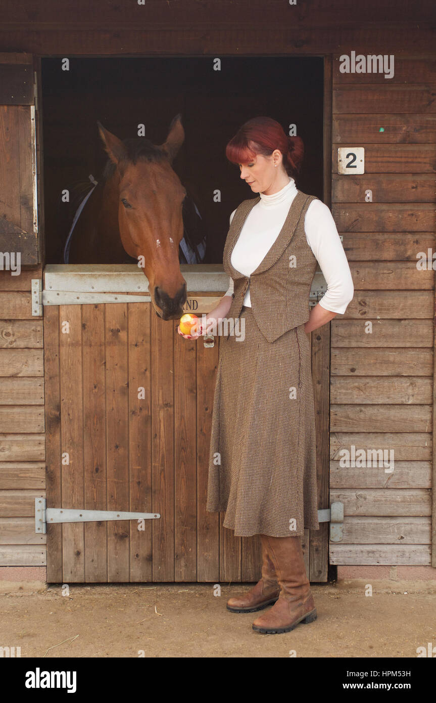 Beautiful woman in gamekeepers tweed suit at a stable Stock Photo - Alamy