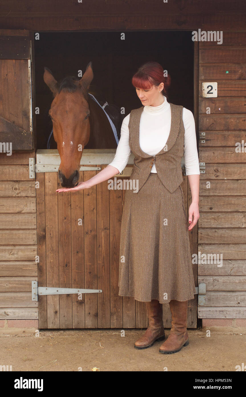 Beautiful woman in gamekeepers tweed suit at a stable Stock Photo - Alamy