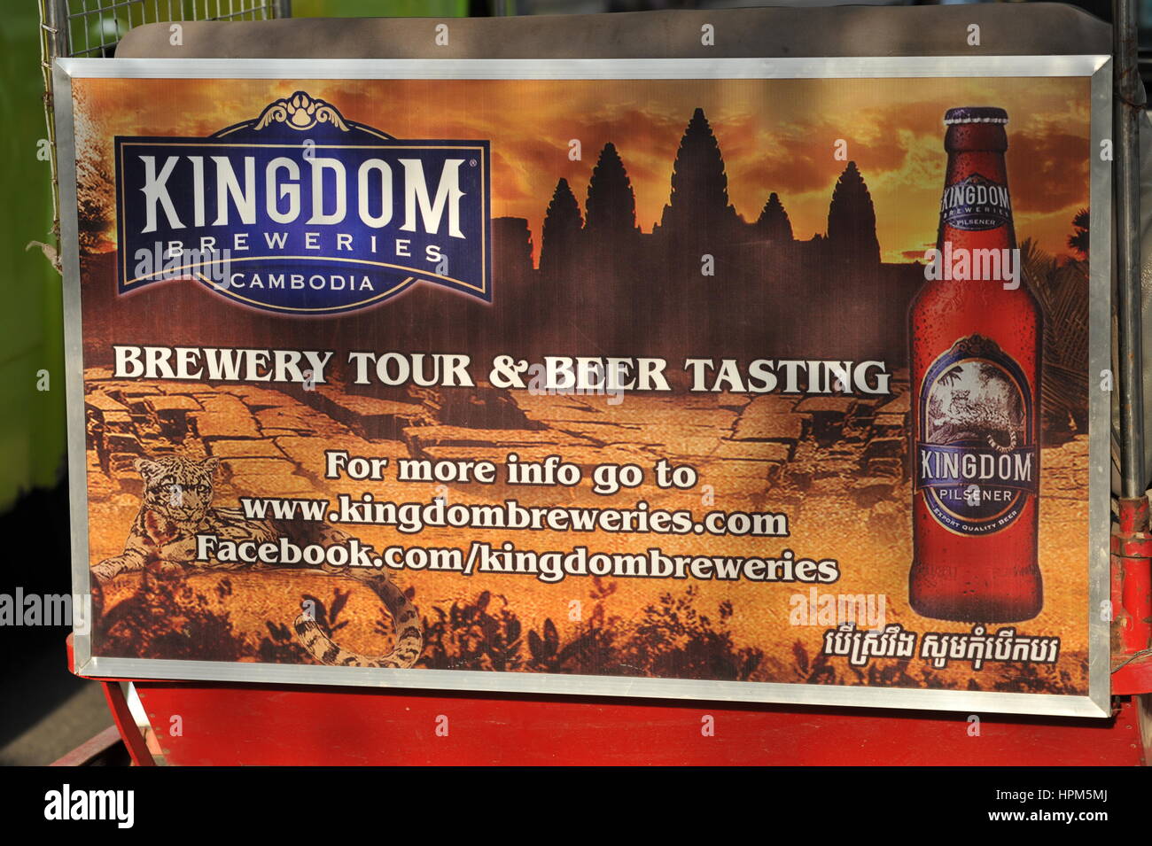 Bilingual sign advertising "Kingdom Beer" on the back of a Tuk-Tuk ...