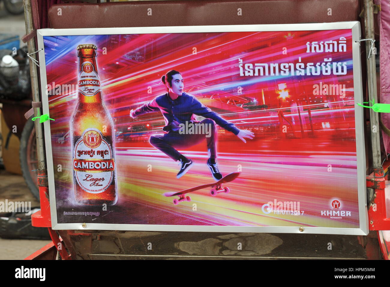 Bilingual sign advertising "Cambodia Beer" on the back of a Tuk-Tuk ...