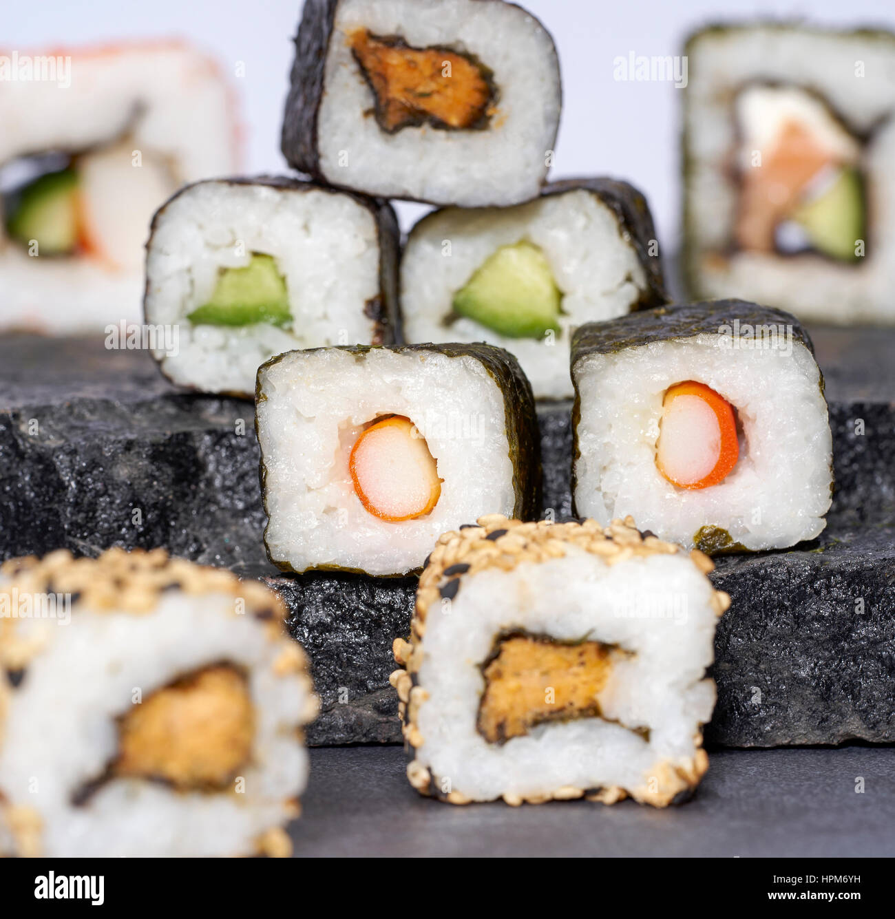 various sushi dishes on dark grey stone surface Stock Photo - Alamy